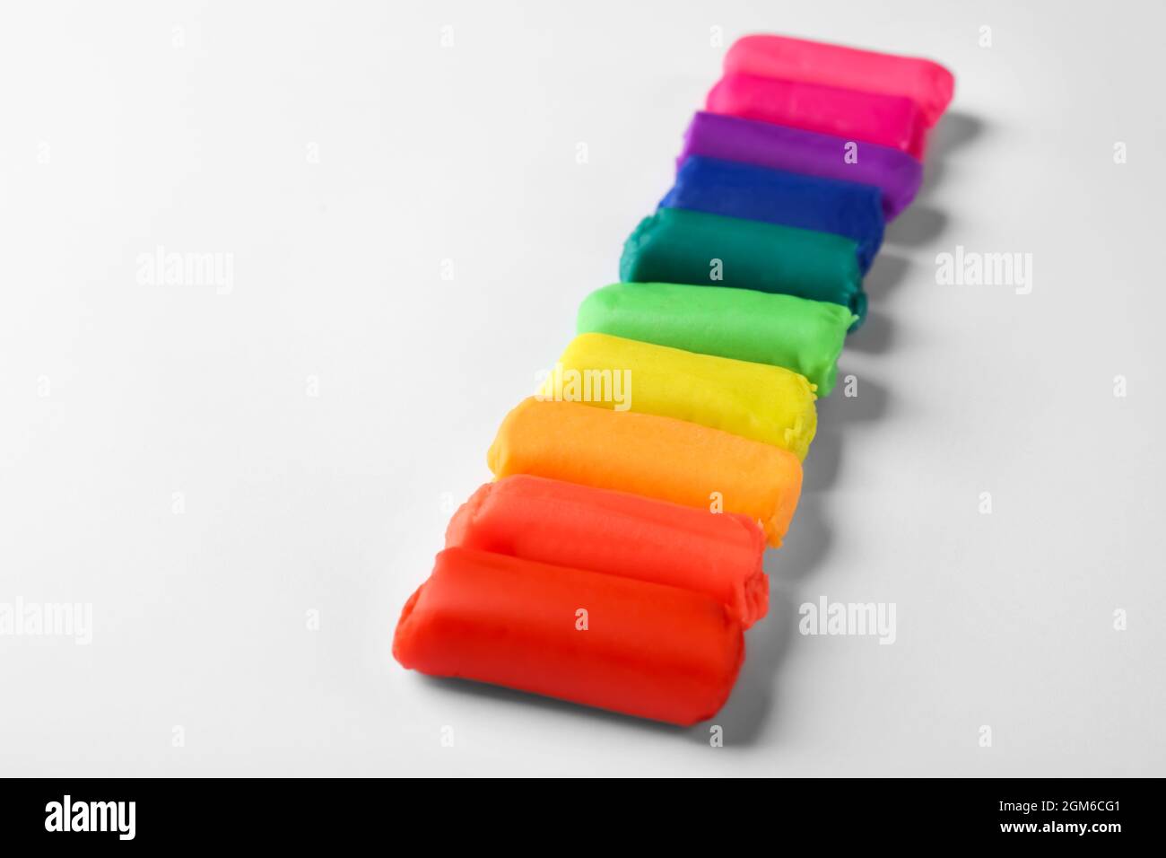 Rainbow play dough on white background Stock Photo - Alamy
