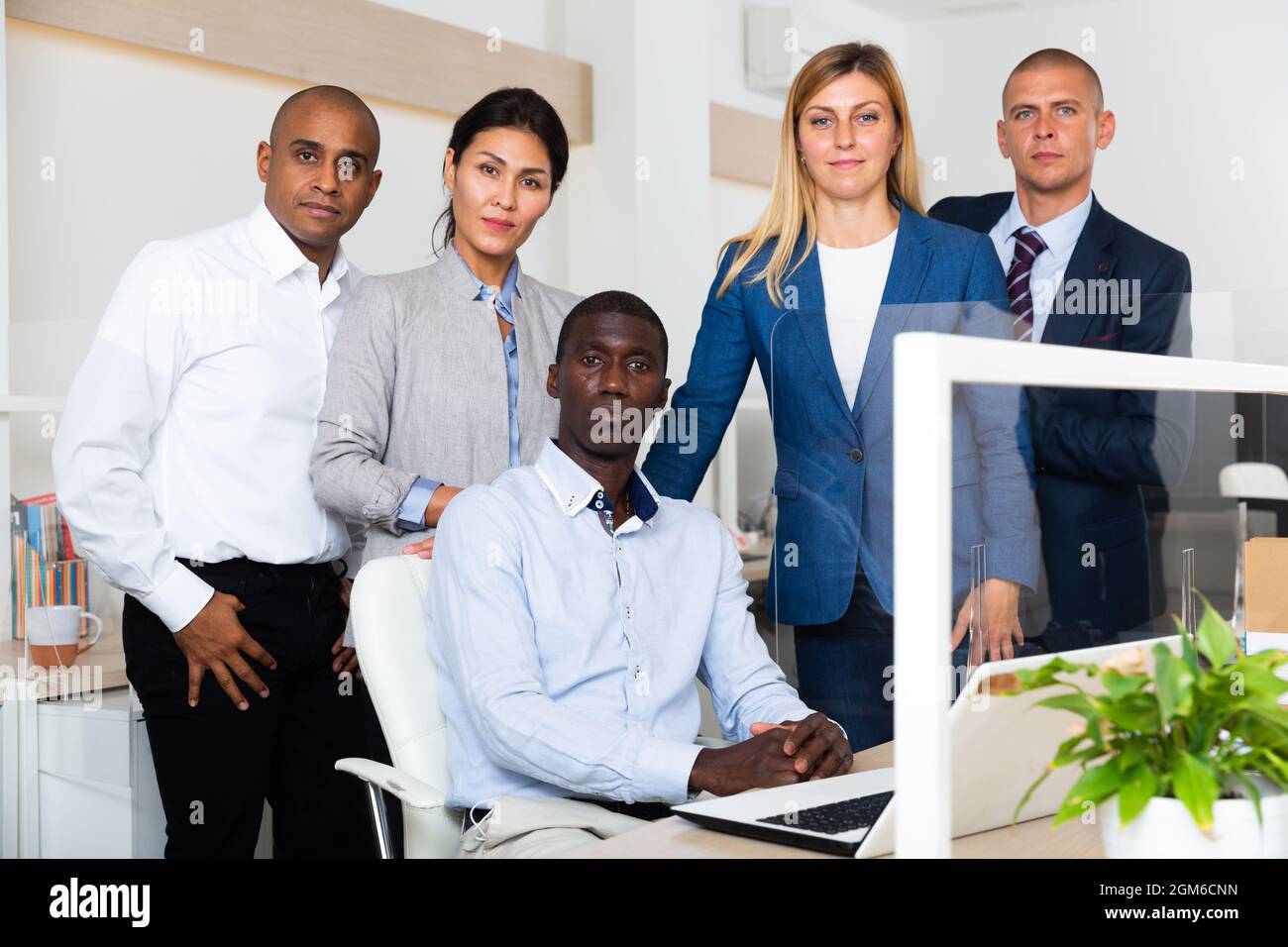 Confident successful multinational business group posing in office ...
