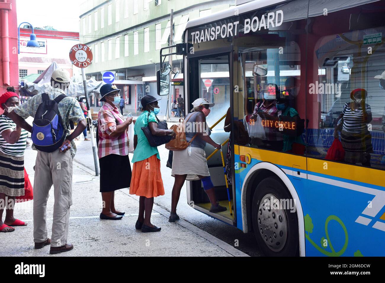 Passengers Boarding a bus in Bridgetown Barbados Stock Photo - Alamy