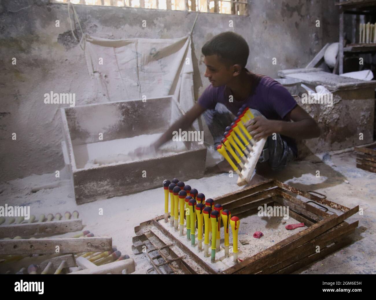 Non Exclusive: An employee works sorting balloons in a balloon factory ...