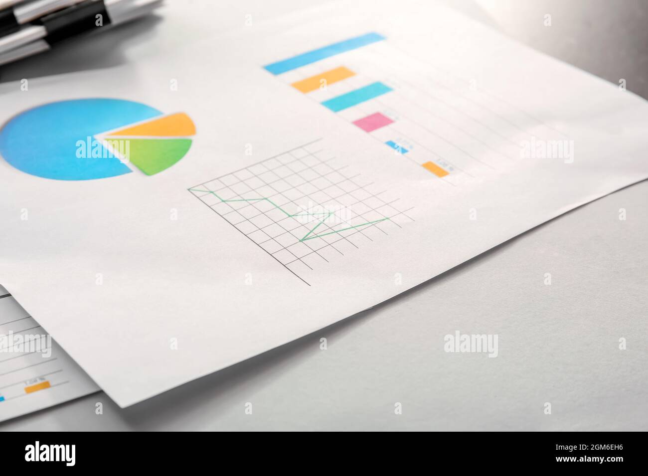Document with graph and diagrams on table Stock Photo - Alamy