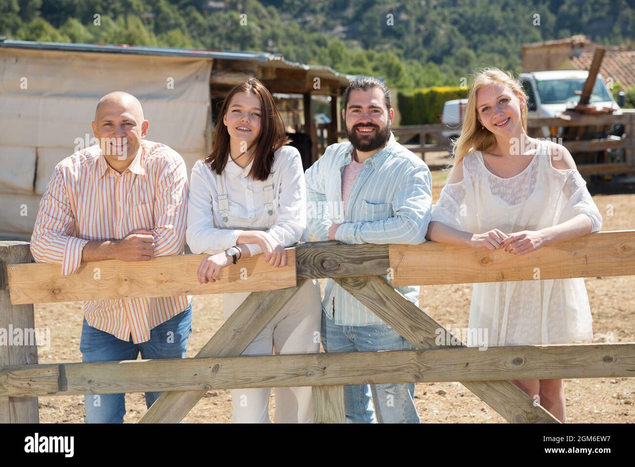 Portrait of four happy friends on a country ranch Stock Photo - Alamy