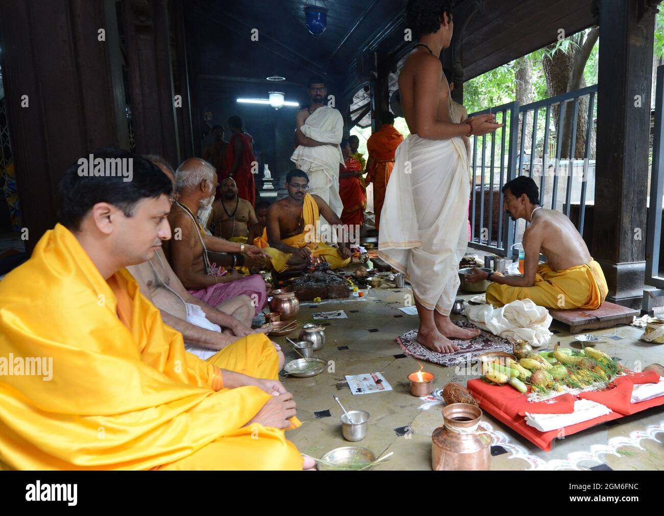 Marathi Hindu priests conducting a religious ceremony in a small temple ...
