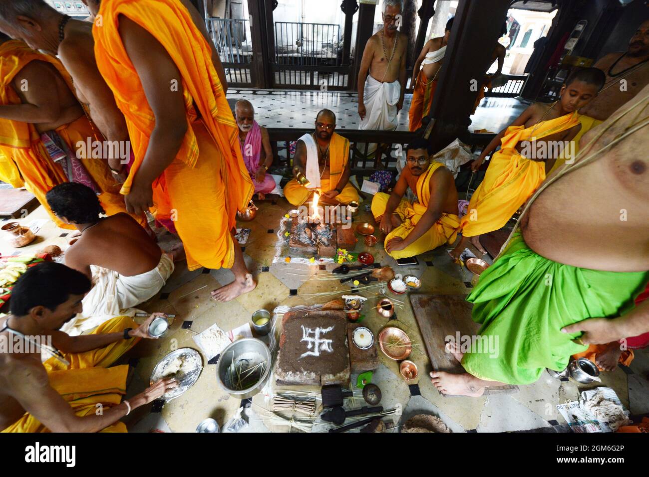 Marathi Hindu priests conducting a religious ceremony in a small temple ...