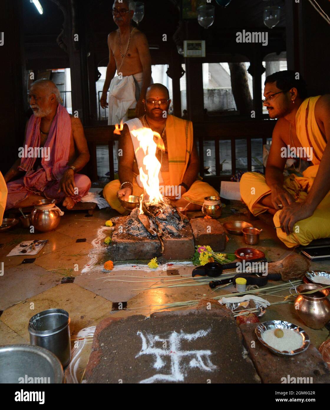Marathi Hindu priests conducting a religious ceremony in a small temple ...