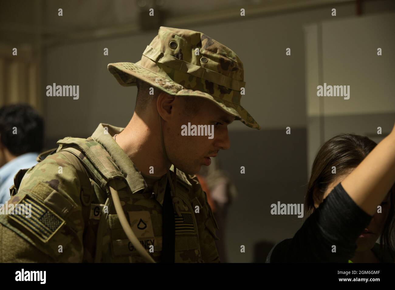 U.S. Army Pfc. David Gainey, from Wilkes-Barre, Pennsylvania, assists a ...