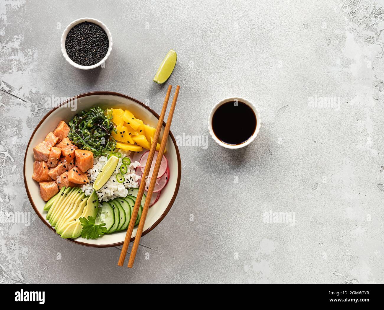 Hawaiian salmon fish poke bowl with rice, mango, radish, cucumber ...