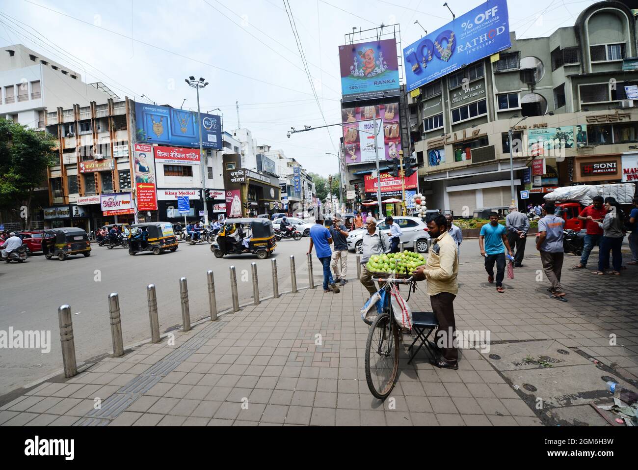 A Marathi man selling guavas from his bicycle at the junction of ...