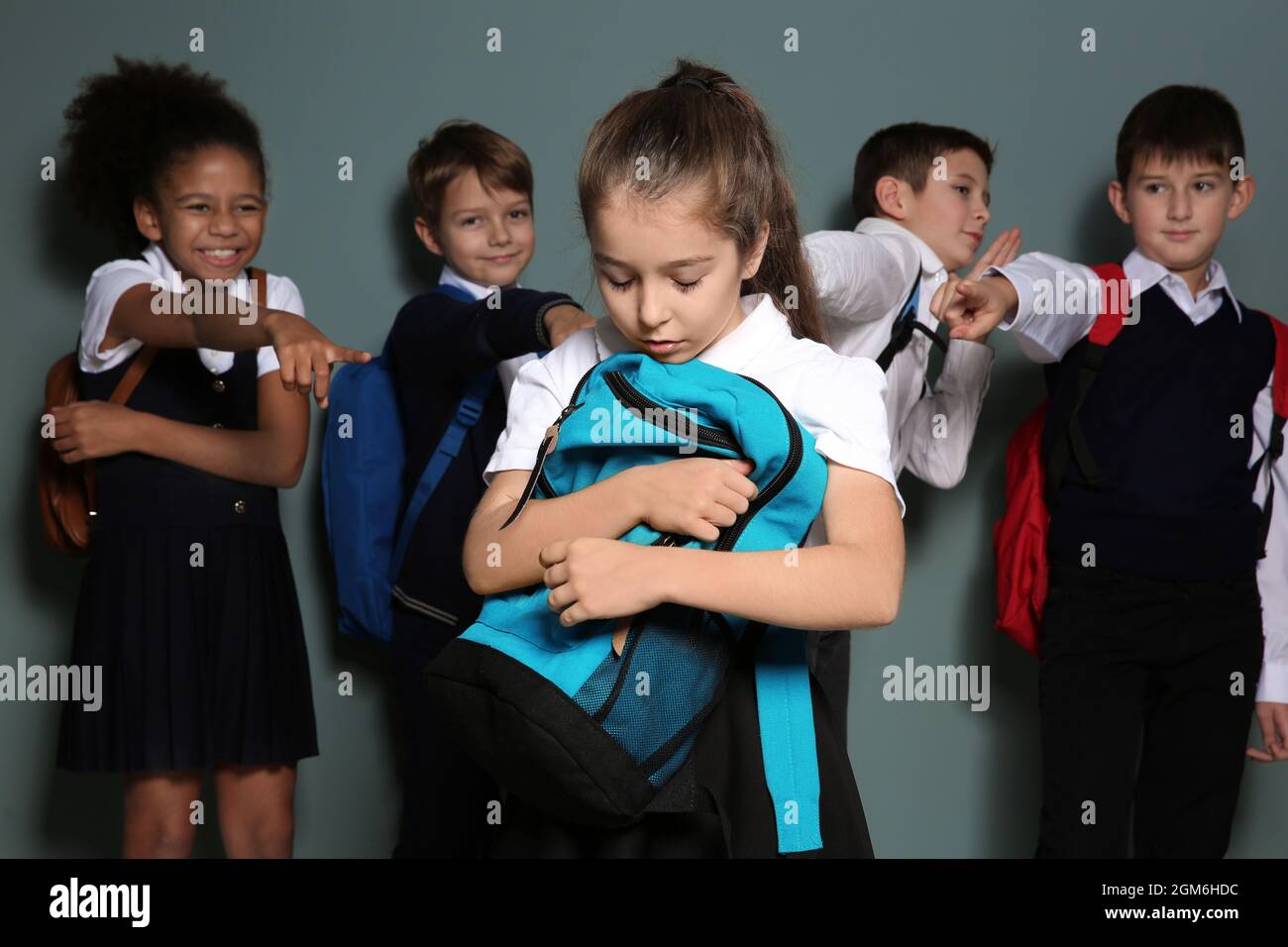Children bullying their classmate on color background Stock Photo - Alamy