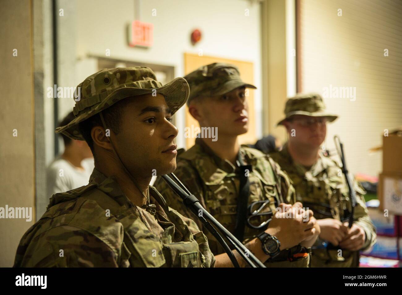 U.S. Army Soldiers guide Afghan evacuees during a clothing distribution ...
