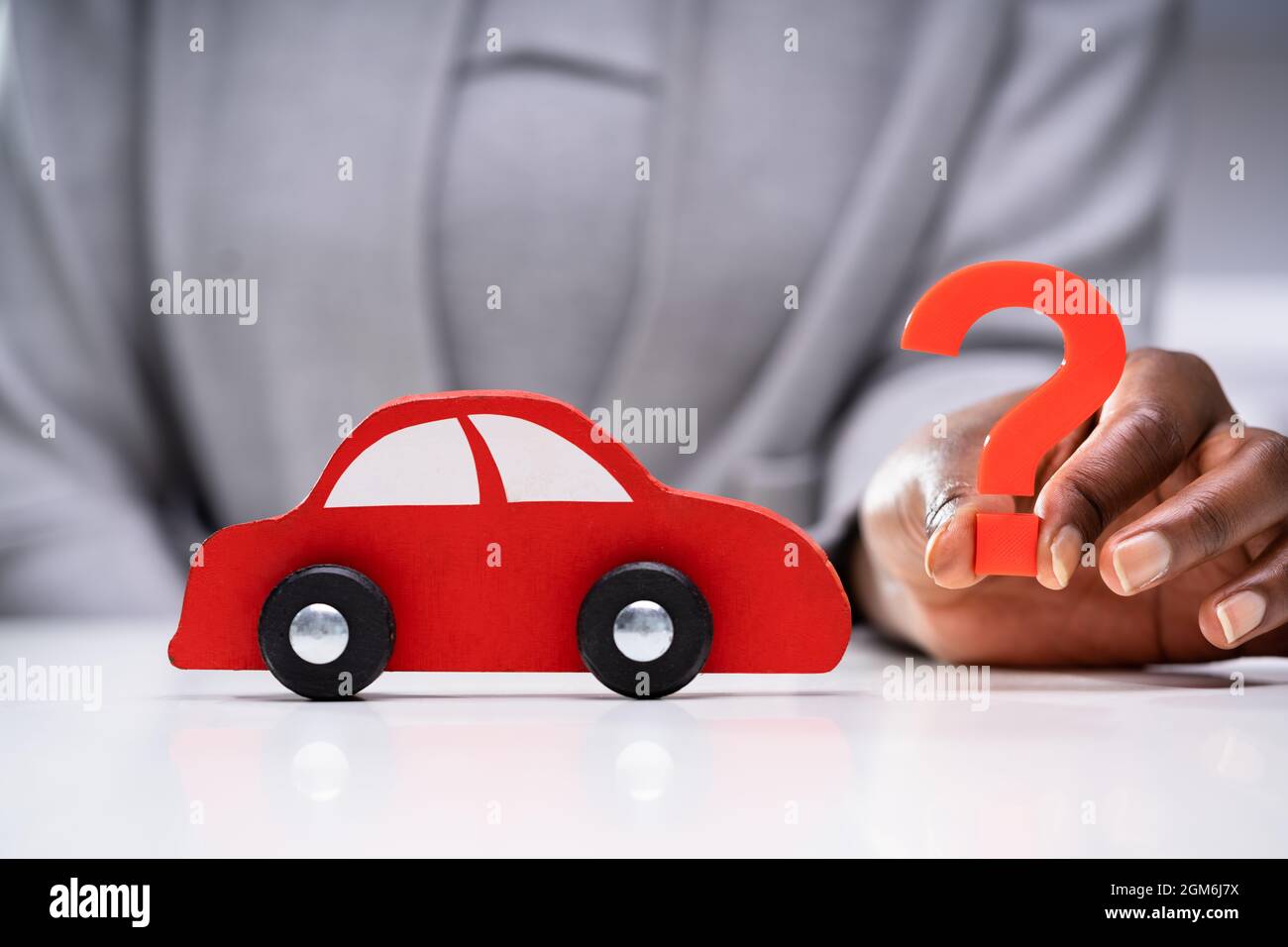 Person Hand Holding Question Mark Next To Car Model Stock Photo - Alamy