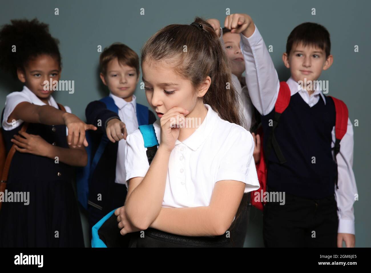 Children bullying their classmate on color background Stock Photo - Alamy