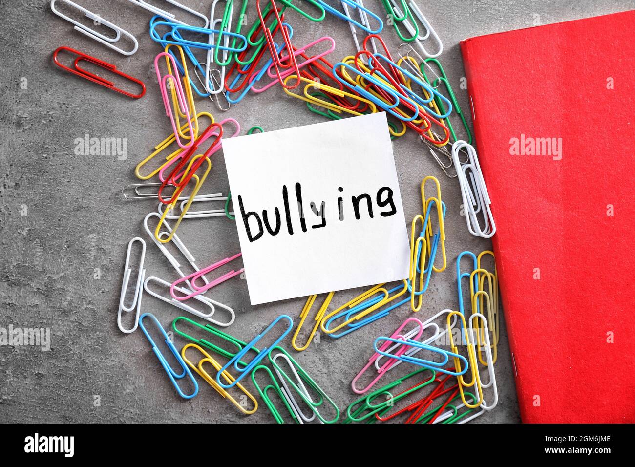 Note with word "Bullying" and paper clips on grey background Stock ...