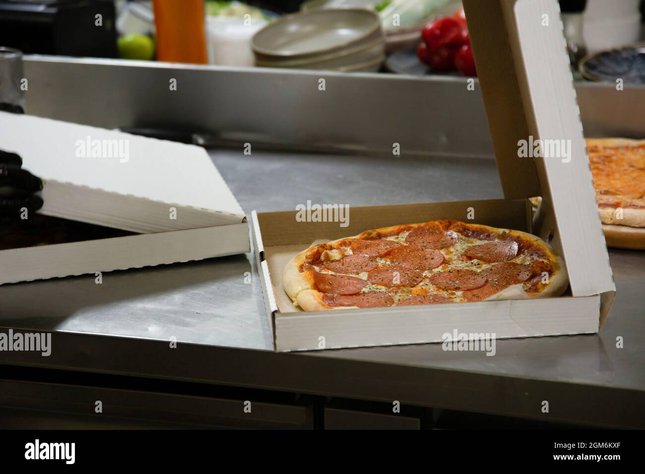 A ready-made dish in a restaurant kitchen. Food packaging and packing ...