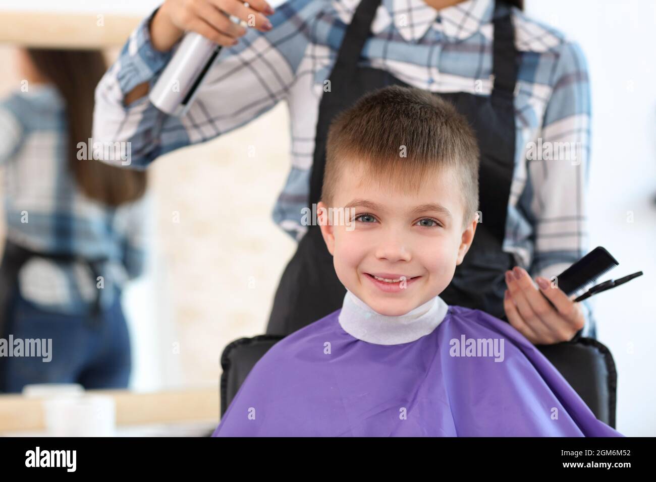 Female hairdresser working with little boy in salon, closeup Stock ...