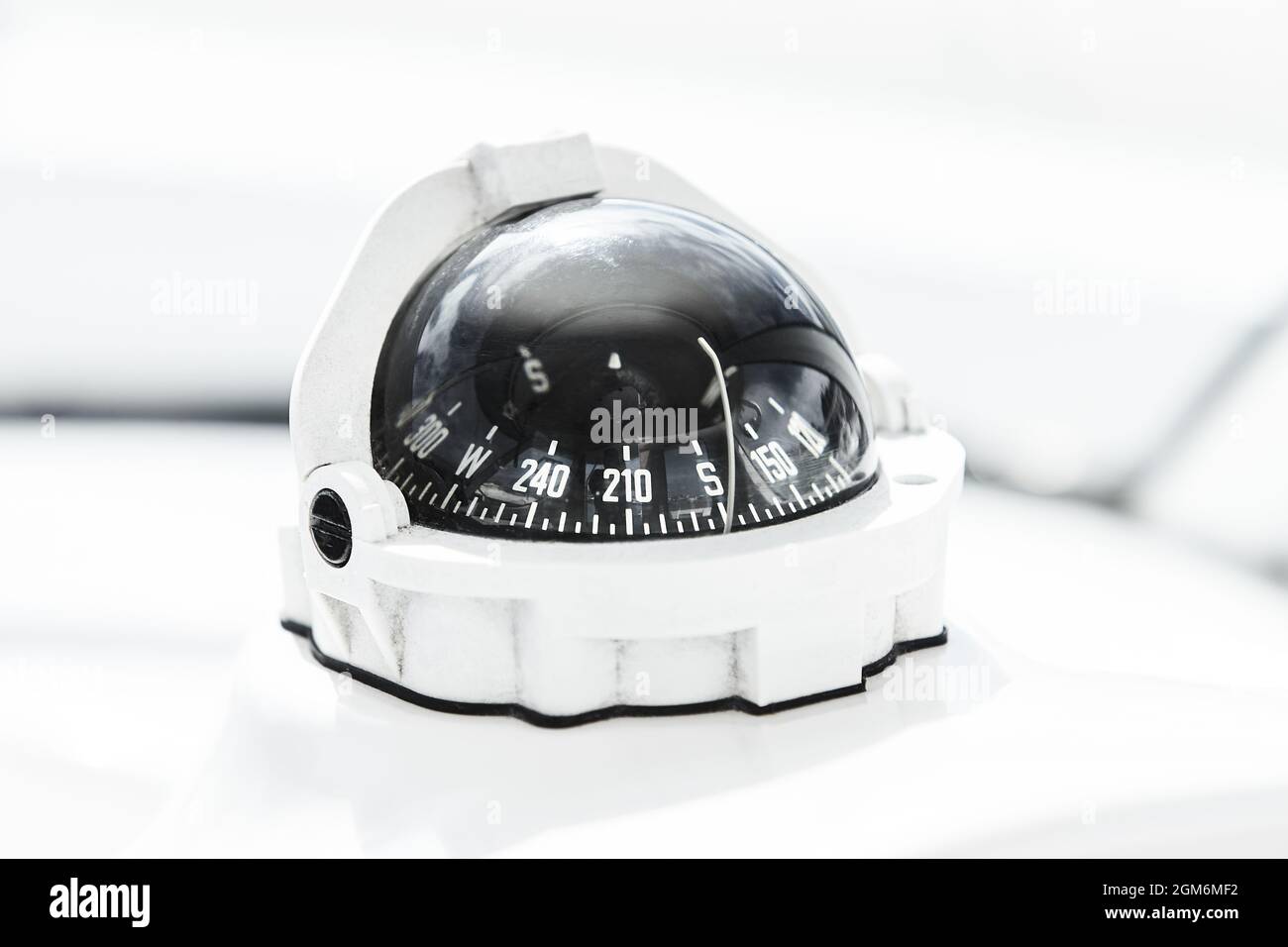 A big compass on a boat showing direction. Harbor background Stock ...