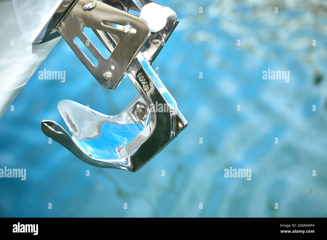 Yacht anchor close-up seen on the front of a luxury boat. Sailboat bow ...