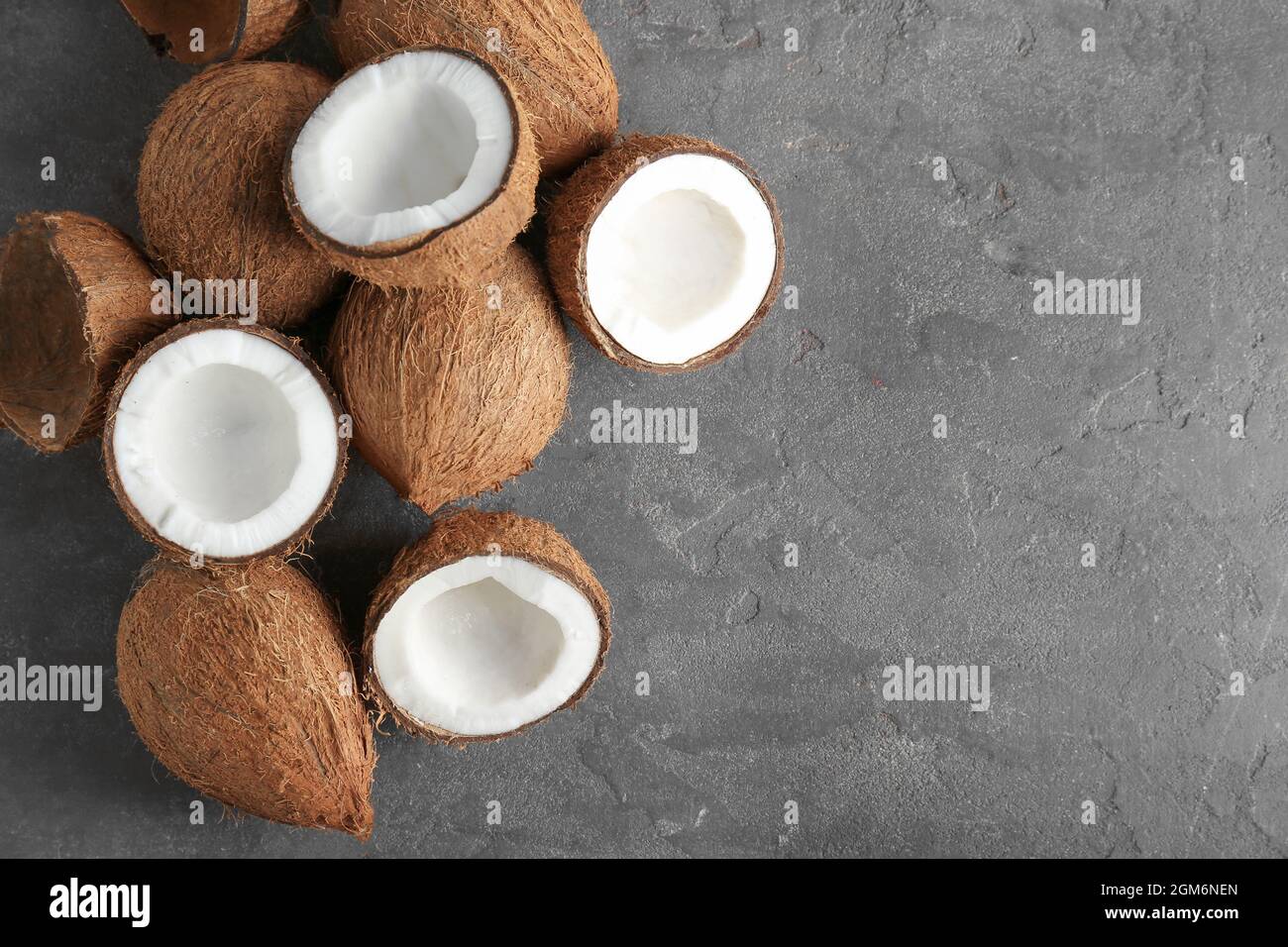 Pile of coconuts on grey background Stock Photo - Alamy