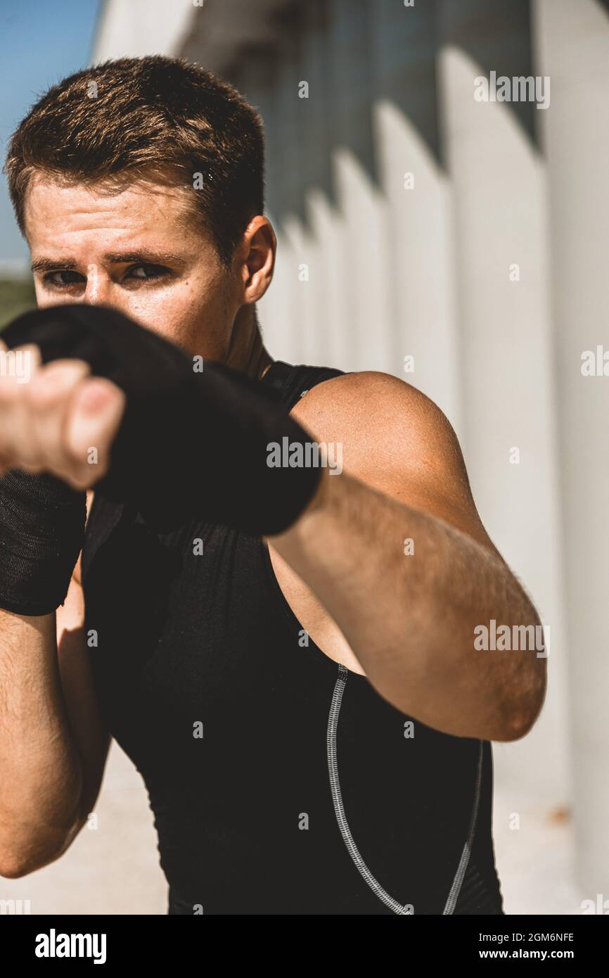 Man exercising and fighting in outside, boxer in gloves. male boxer ...