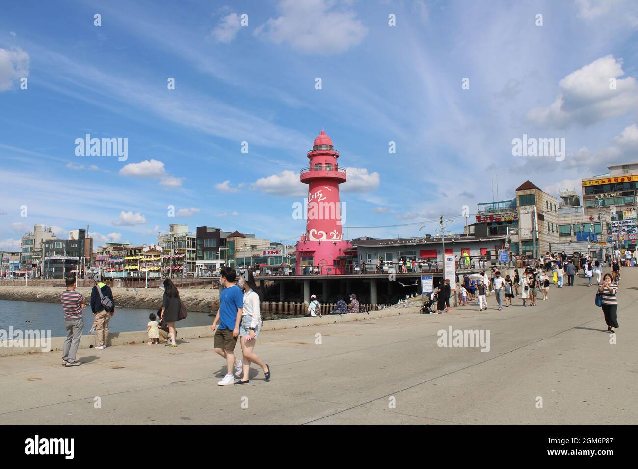 People congregating around the famed Red Lighthouse, in Oido, Korea ...