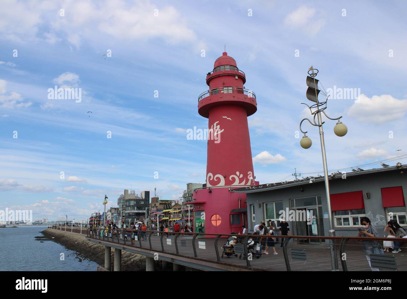 People congregating around the famed Red Lighthouse, in Oido, Korea ...