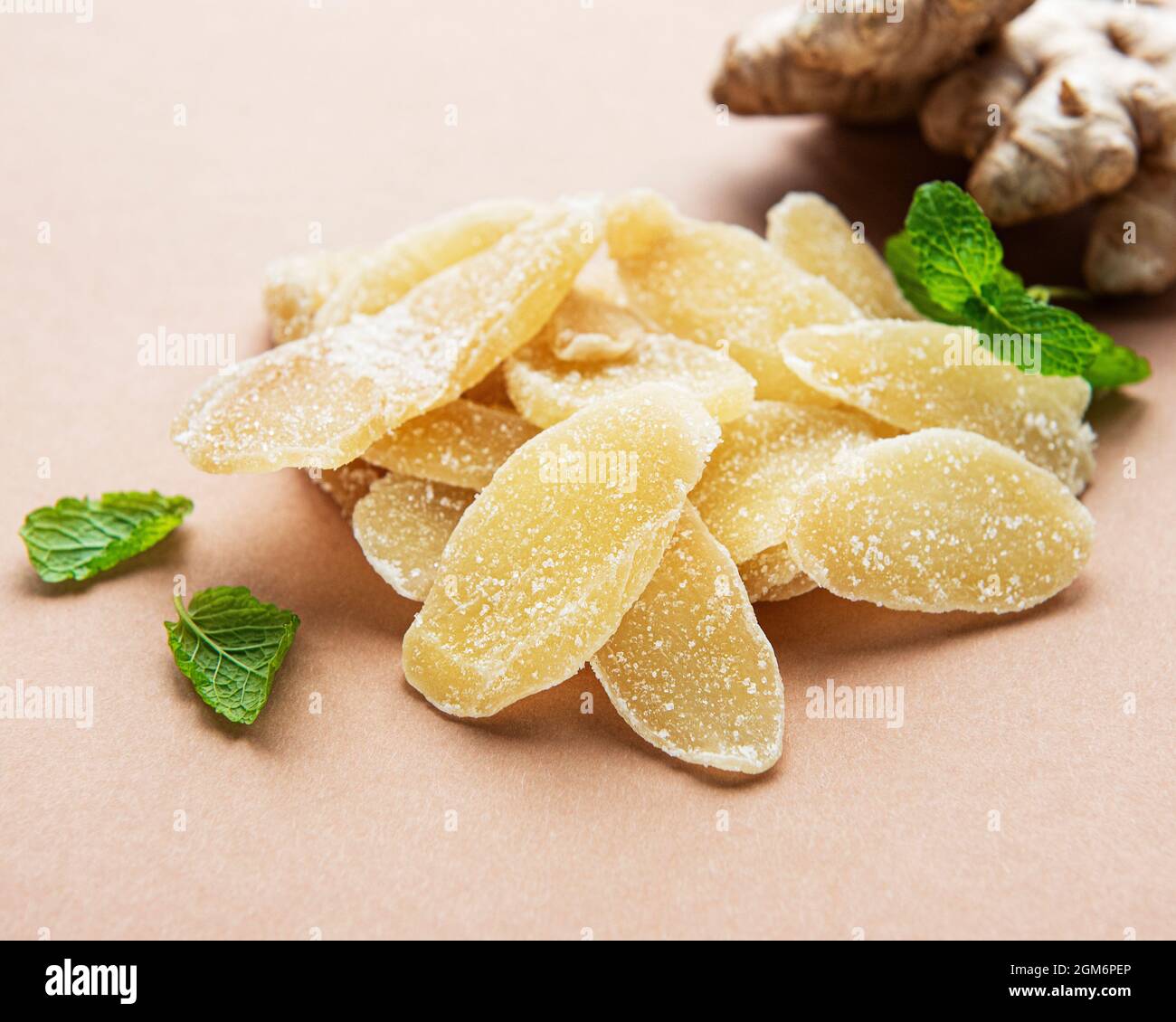 Sweet and spicy candied ginger on a brown background Stock Photo - Alamy