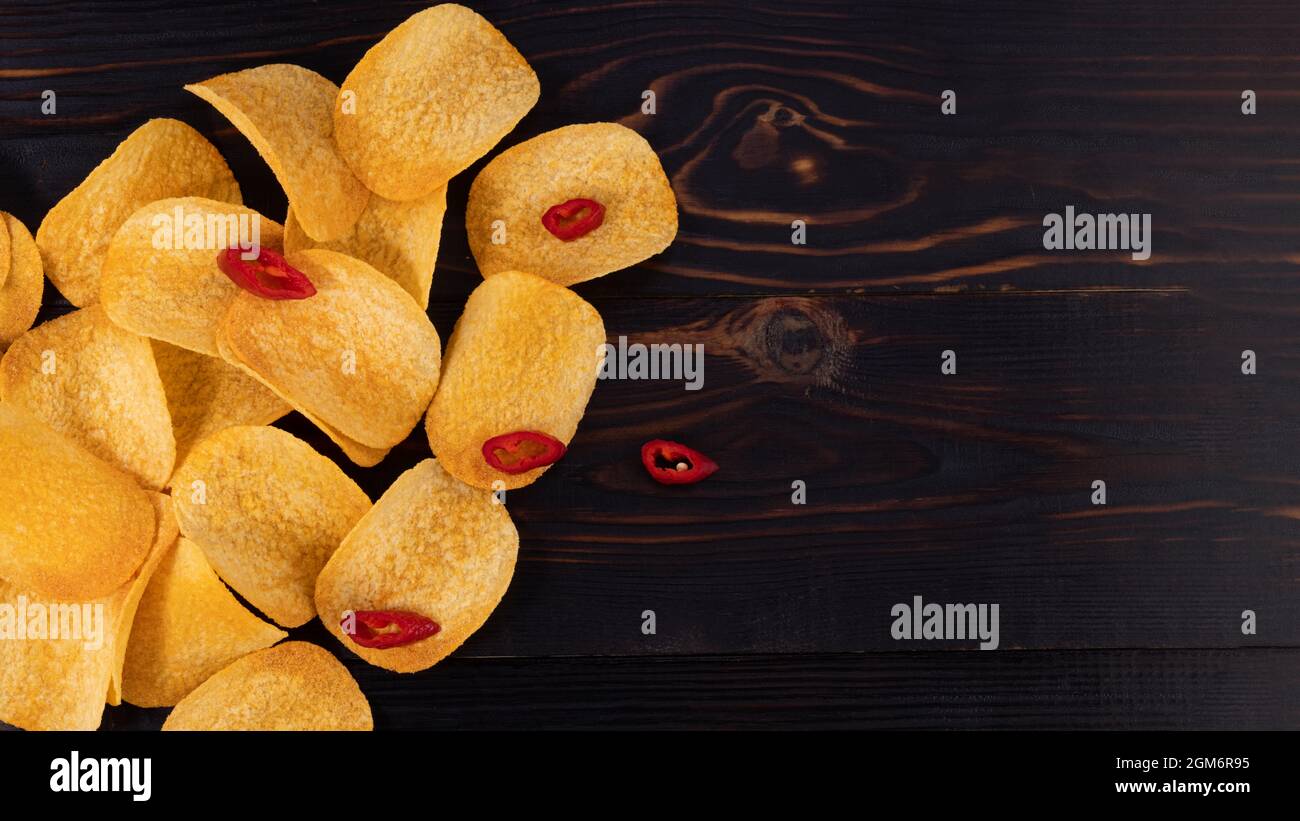 potato chips with hot peppers on wood background top view with copy ...