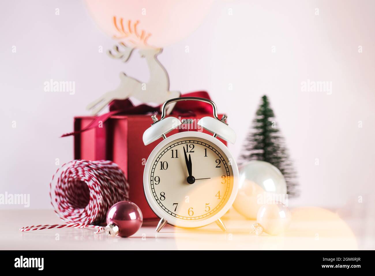 Christmas composition with alarm clock baubles and gift box. Copy space ...