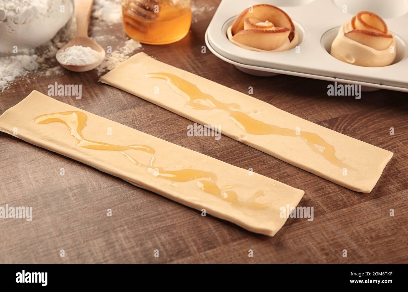 Raw pastry with honey on table Stock Photo - Alamy