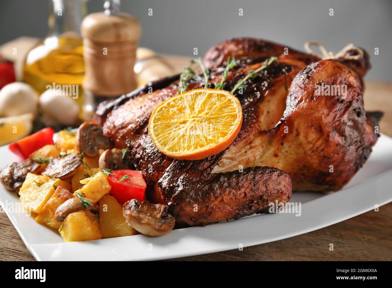 Delicious whole roasted chicken served on plate Stock Photo - Alamy