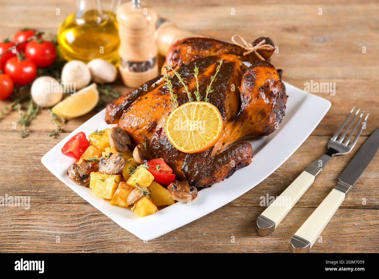 Delicious whole roasted chicken served on plate Stock Photo - Alamy