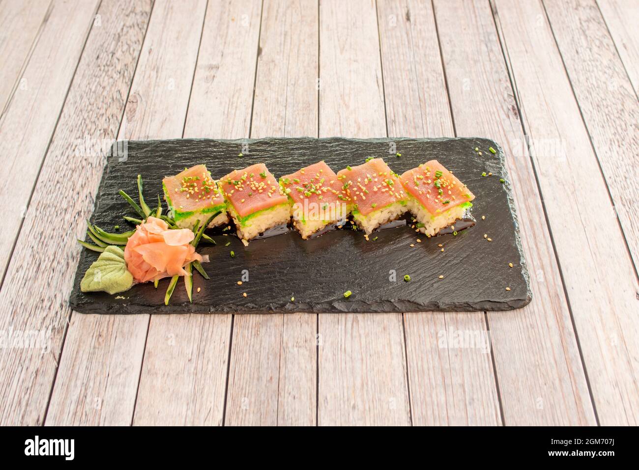 Tuna sushi in squares with green masago roe and wasabi Stock Photo - Alamy