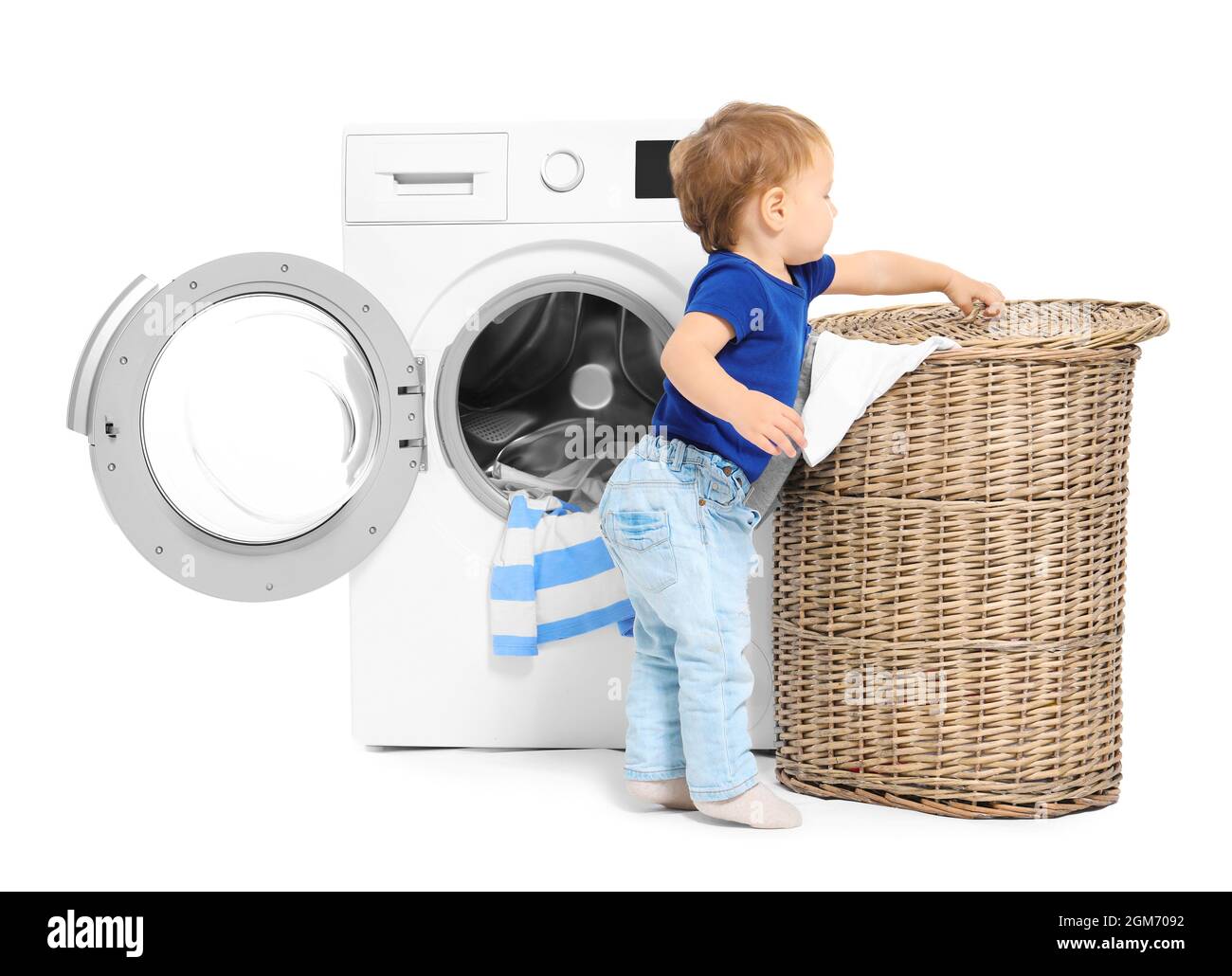 Cute little boy doing laundry on white background Stock Photo - Alamy