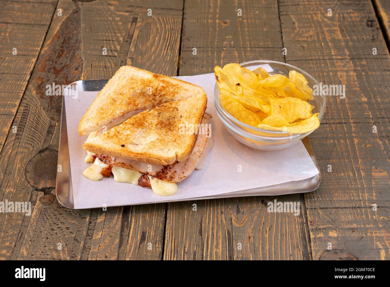 Mixed sandwich with toasted sliced bread, grilled ham and melted cheese ...