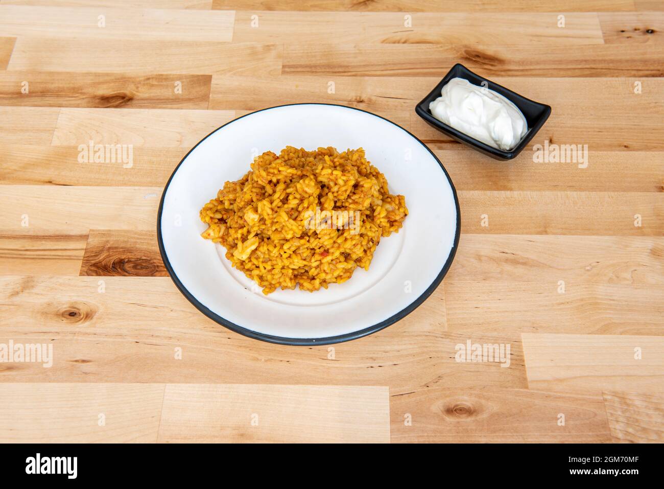Traditional Spanish rice tapa a banda. White enameled plate with rice ...