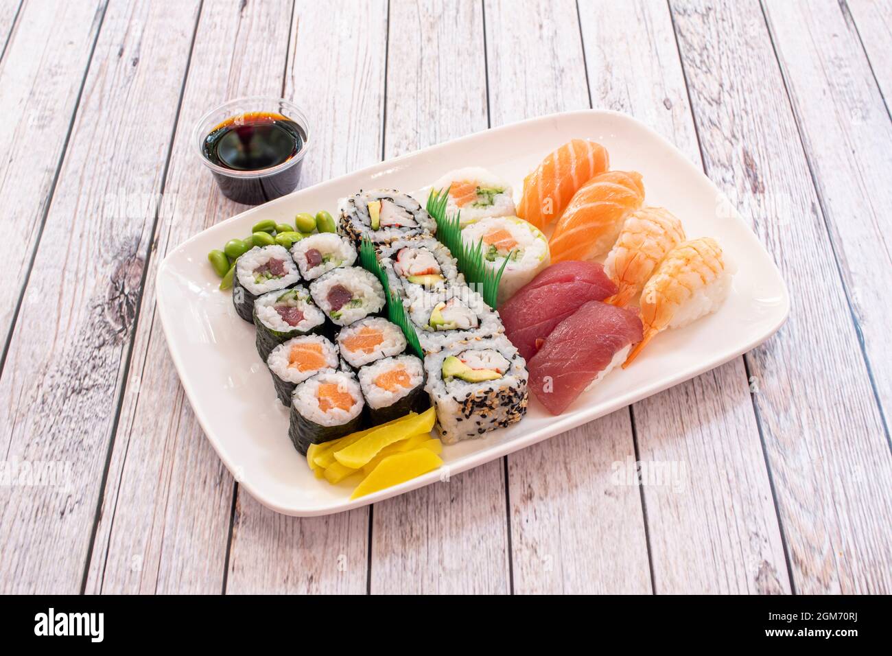 Assorted sushi tray with salmon and tuna maki, surimi uramaki ...