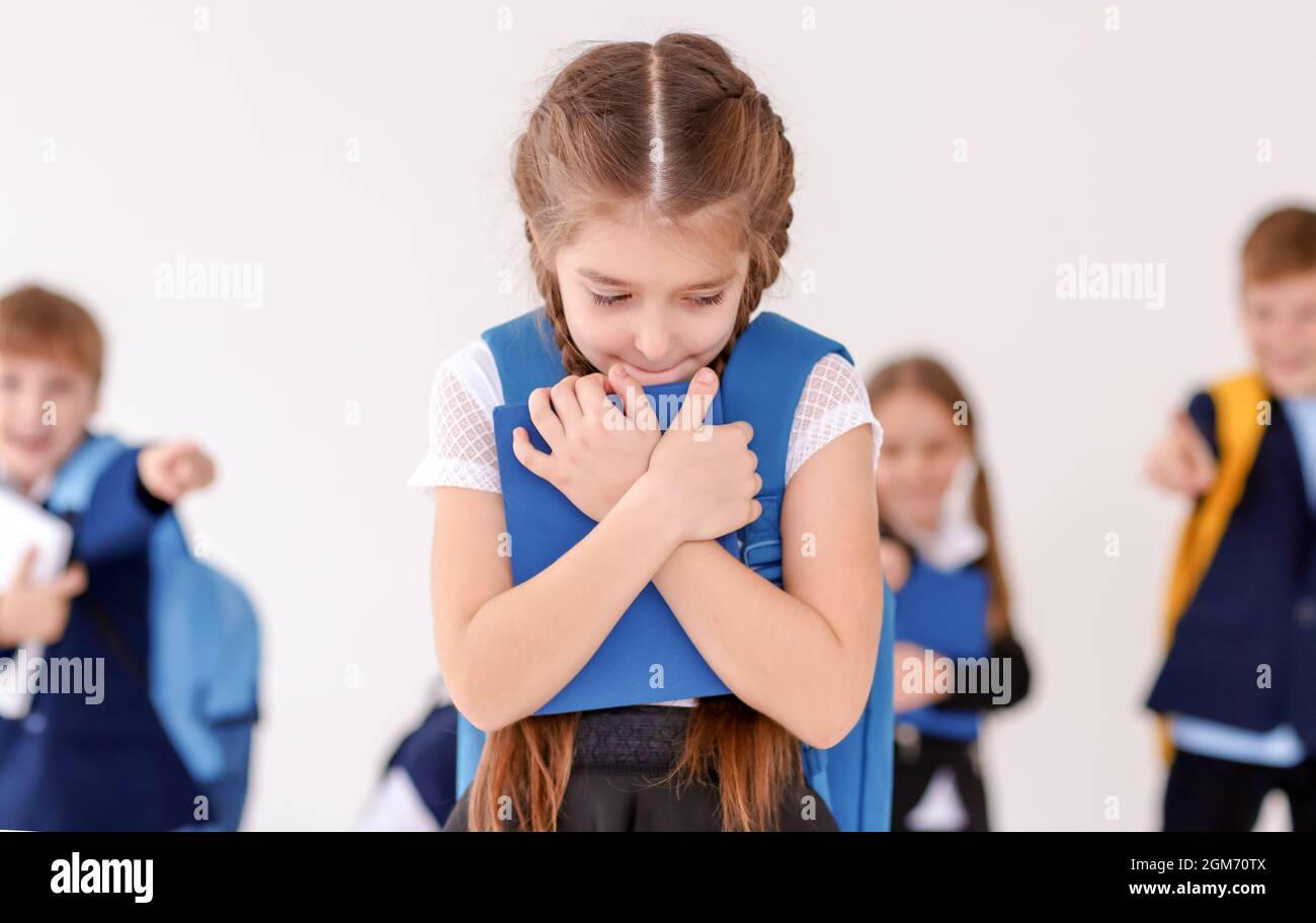 Children bullying their classmate on light background Stock Photo - Alamy