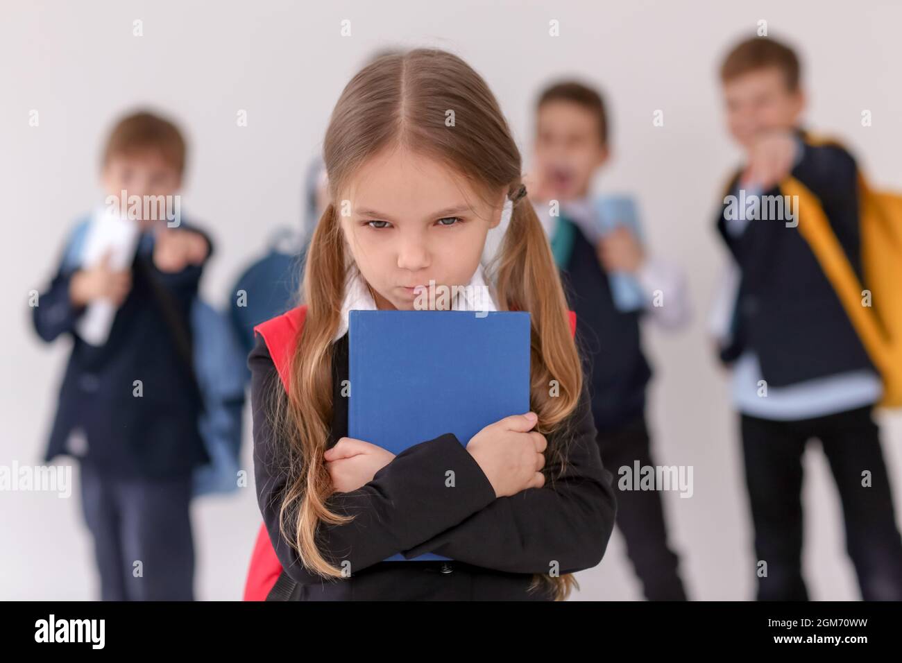 Children bullying their classmate on light background Stock Photo - Alamy