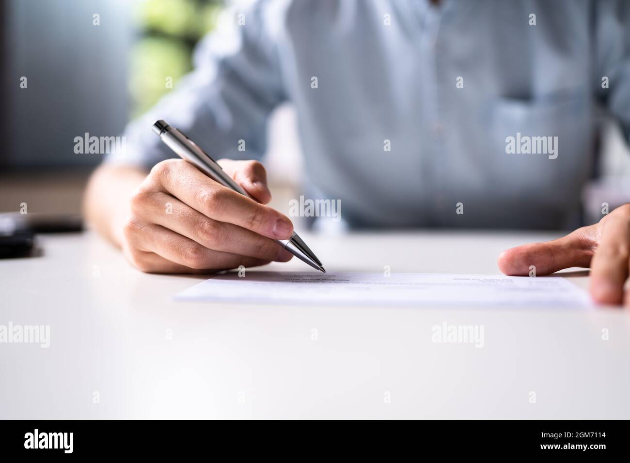 Writing And Signing Check Document. Paycheck Signature Stock Photo - Alamy