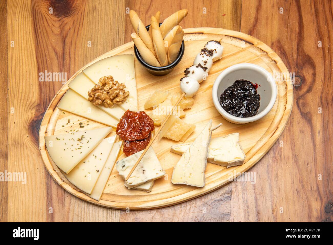 Typical table of assorted cheeses viewed from above with dried tomato ...