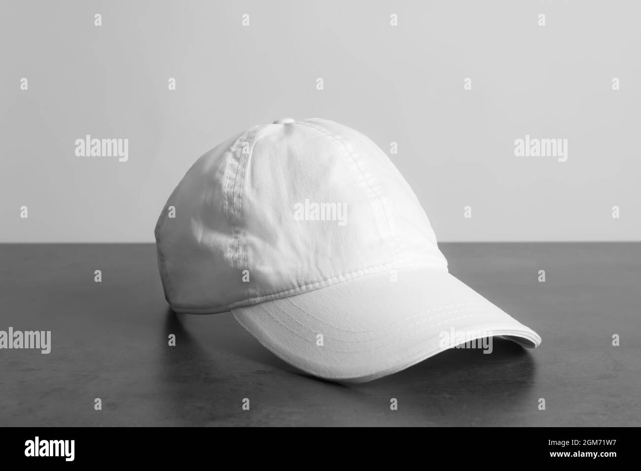 Cap on table against white background. Mockup for design Stock Photo ...