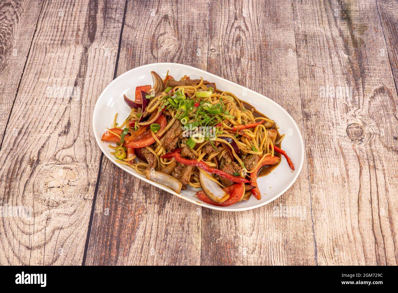 Peruvian sautéed noodles with strips of tenderloin, onion pieces ...