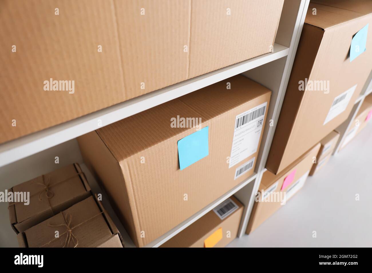 Shelving with parcels ready for shipment to customers in home office ...