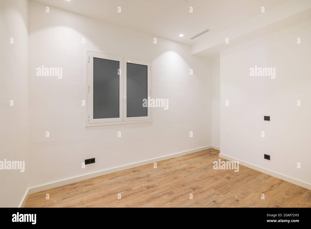 Empty clean room after renovation with white walls, window and wooden ...