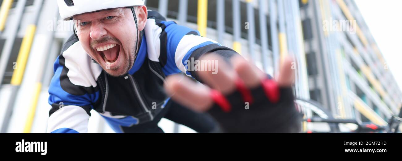 Cyclist in helmet falling off his bike and screaming Stock Photo - Alamy