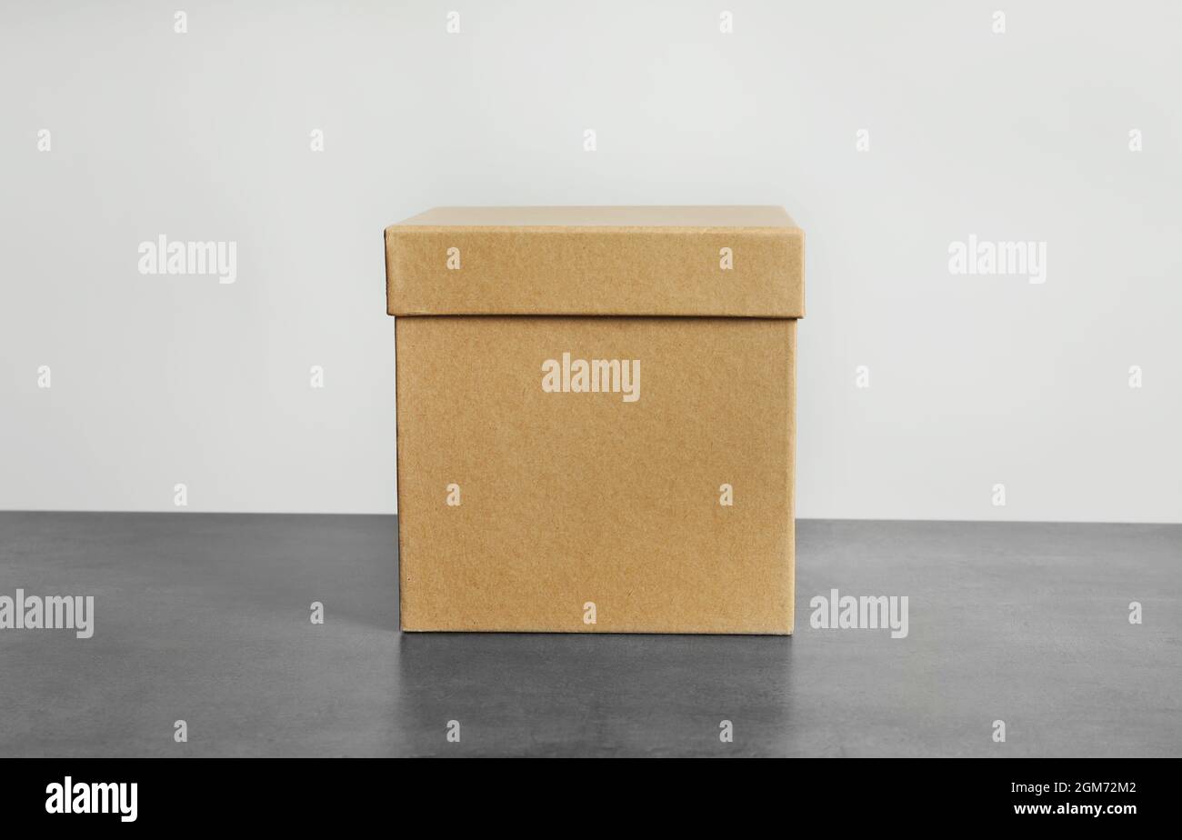 Cardboard box on table against white background. Mockup for design ...
