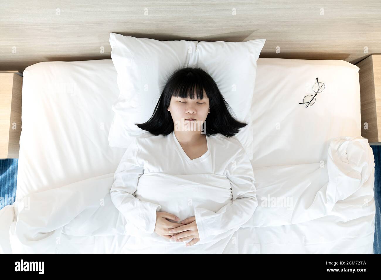 Asian woman sleeps on white bed after exhausted and tried all day Stock ...