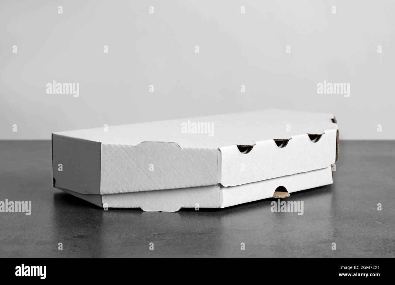 Cardboard box on table against white background. Mockup for design ...