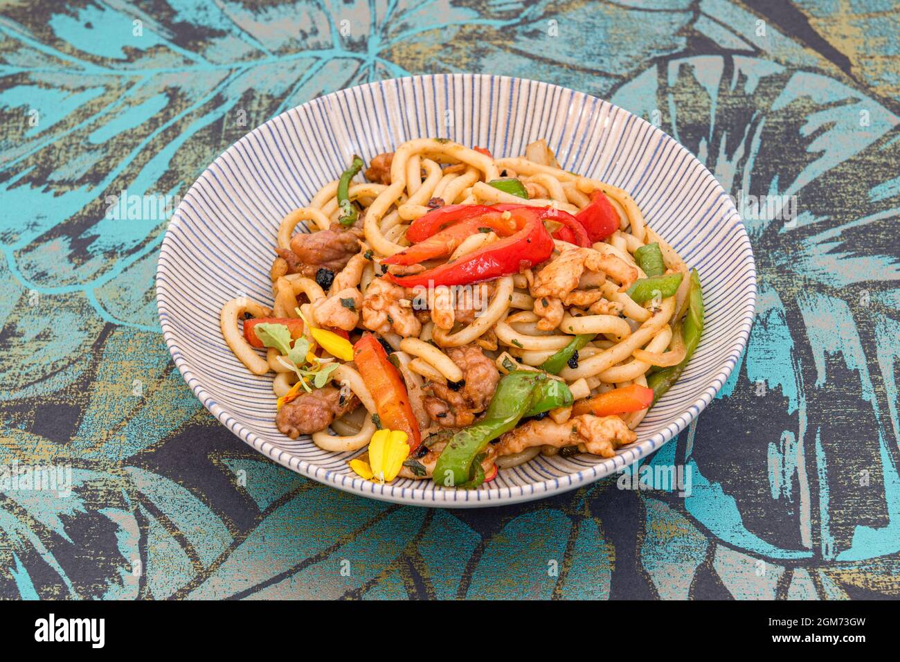 Chubby udon noodles sautéed with red and green peppers, pig meat ...