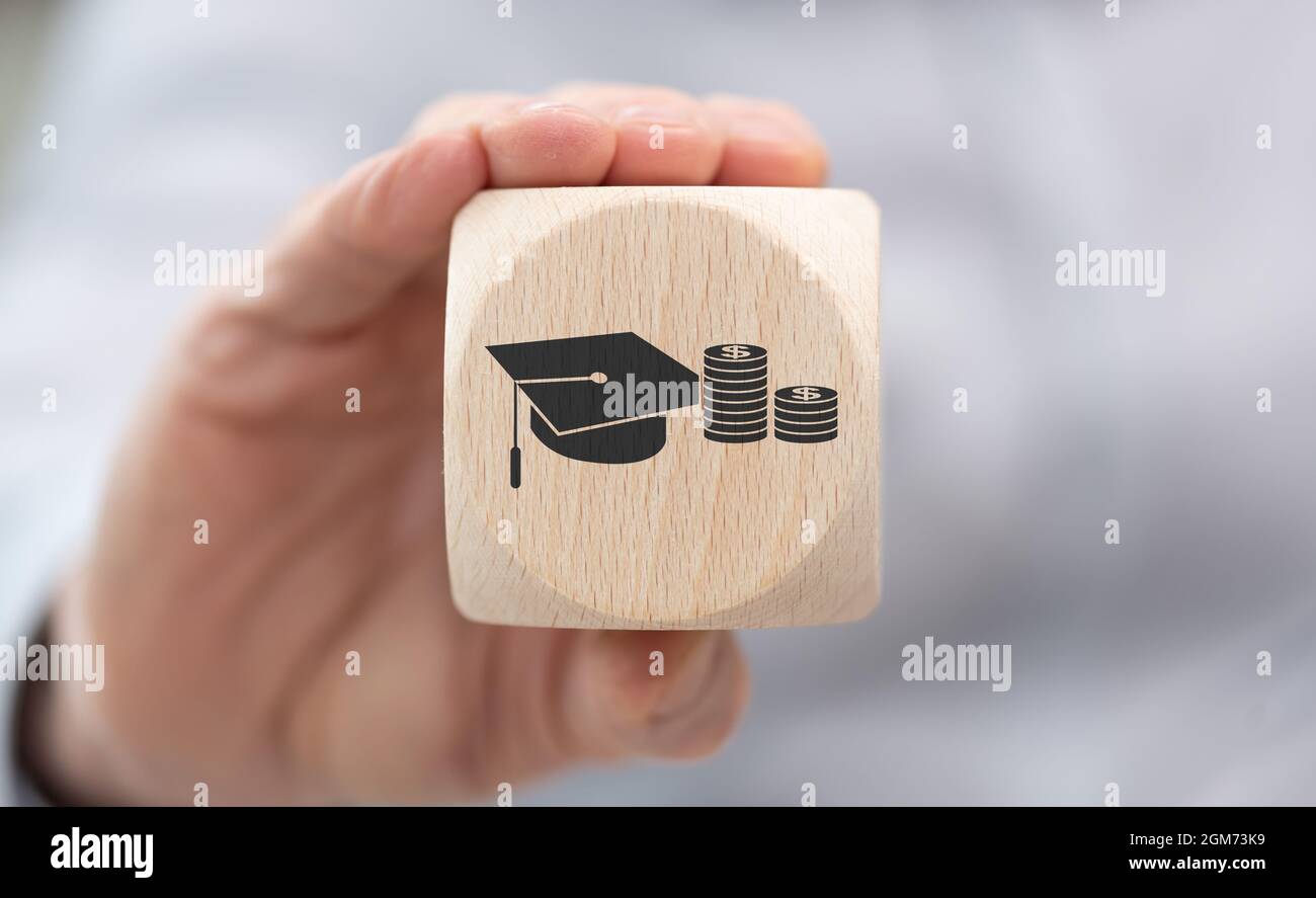 Hand holding a wooden cube with symbol of fafsa concept Stock Photo - Alamy